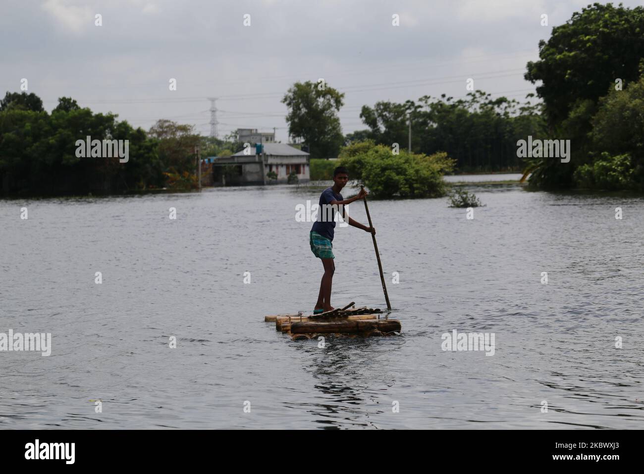A flood affected boy rides makeshift raft in the floodwater in ...
