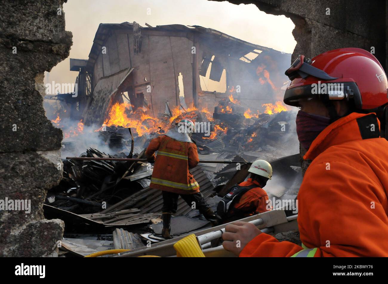 Officers extinguish the fire when a fire ravaged the wooden furniture ...