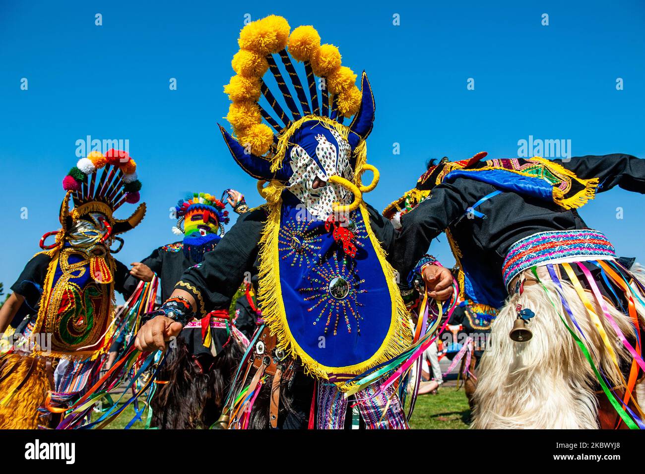 People are carrying out a Bolivian traditional dance wearing ...