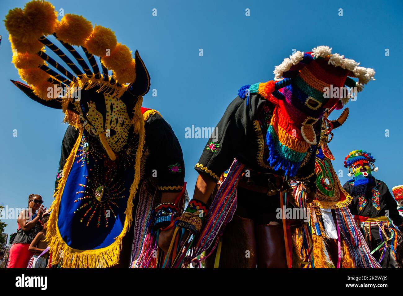 People are carrying out a Bolivian traditional dance wearing ...