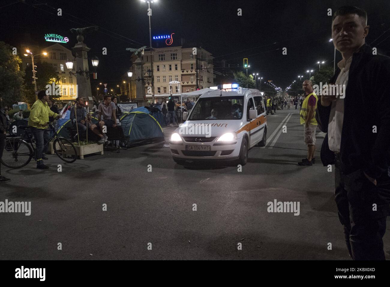 An ambulance is given room to pass through a protest camp at Orlov Most ...