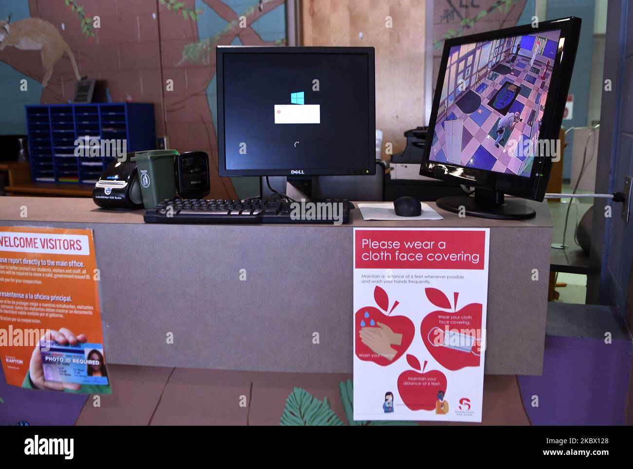 Heath safety precautions are seen posted at the reception desk at Layer ...