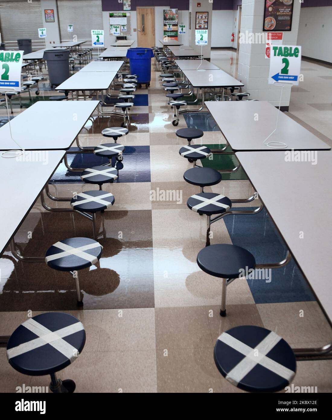 The cafeteria with seats designated to provide social distancing is ...