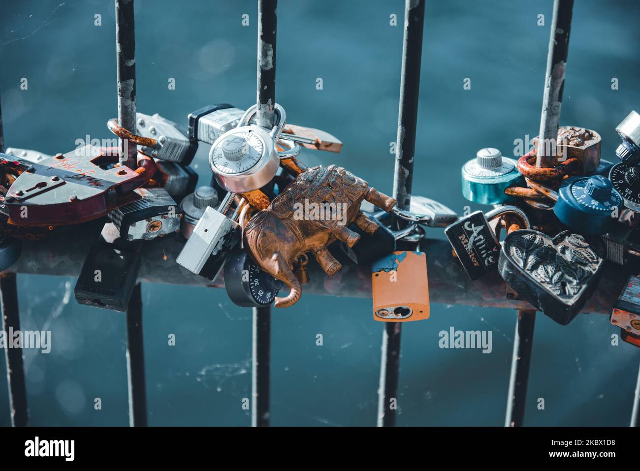 A closeup of locks of love put on a bridge over flowing water in Evans ...