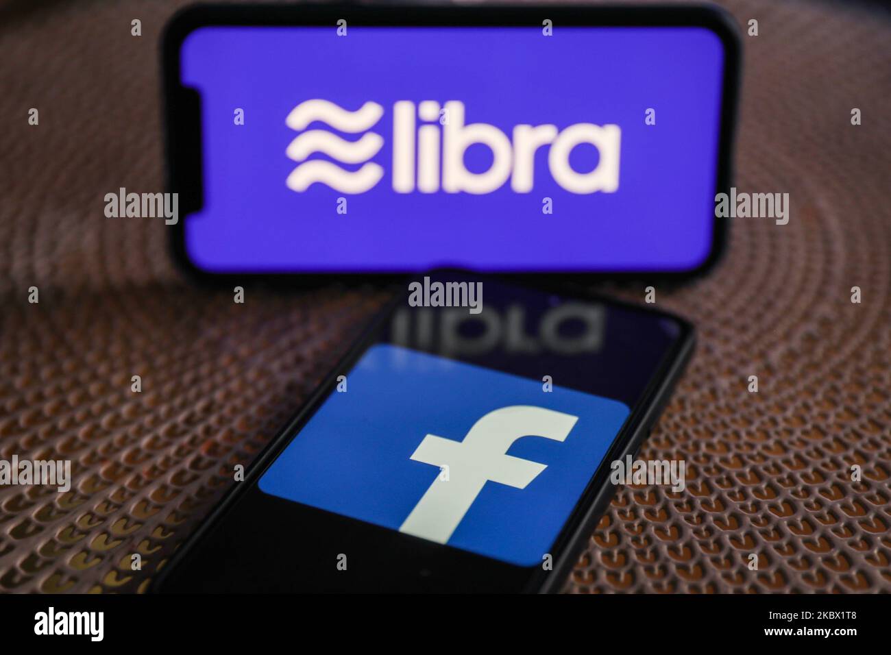 Logos of Facebook and Libra are seen displayed on a smartphones in this ...