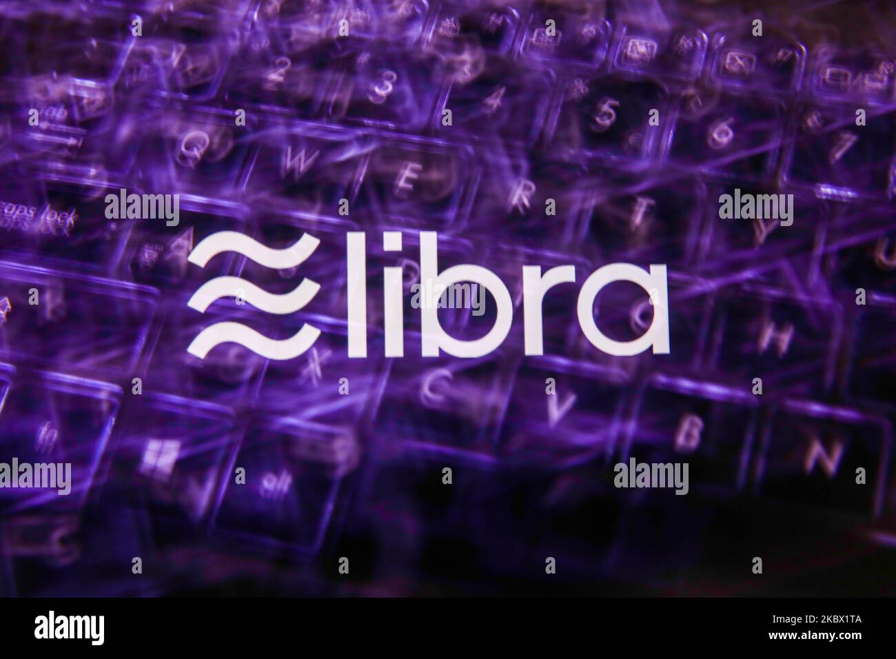 Logo of Libra digital currency displayed on a phone screen and a ...