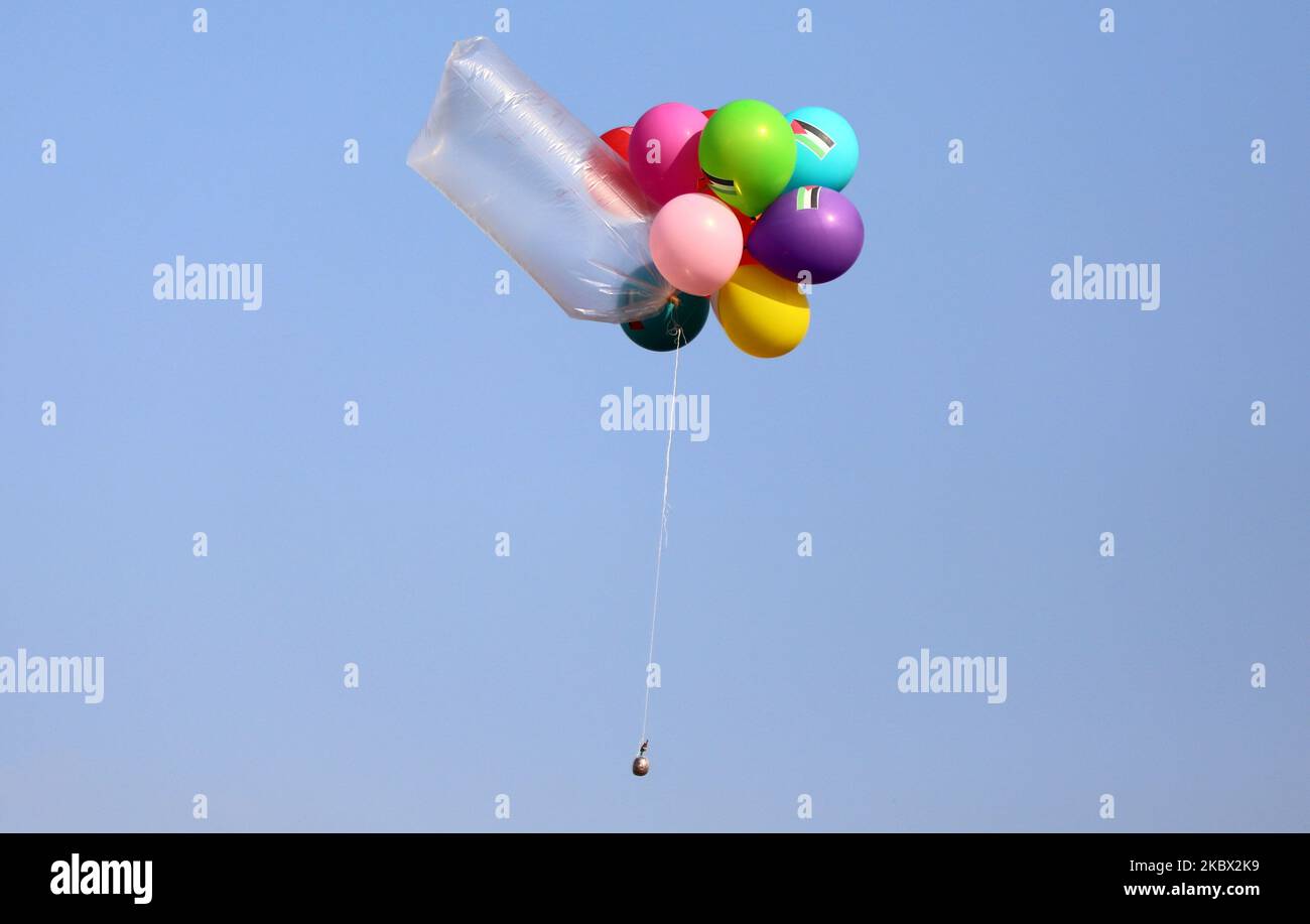 Balloons carrying an incendiary device floats after being released ...