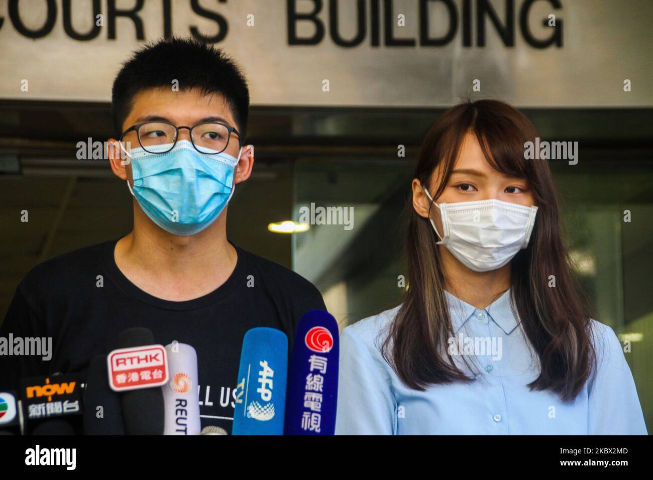 Joshua Wong (left) and Agnes Chow (right) address the press outside ...