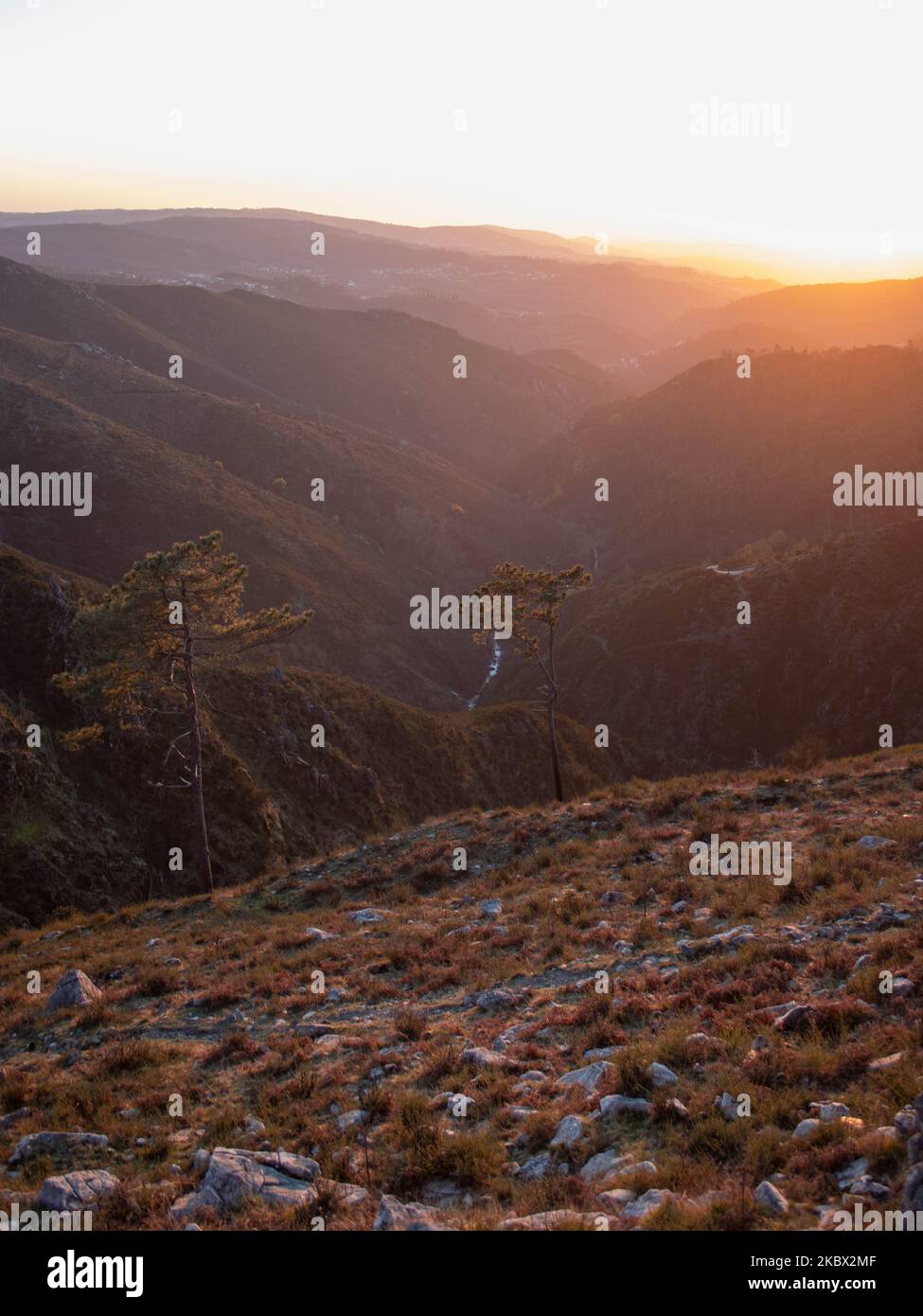 A vertical of mountain ranges under sunlight from a rocky land Stock ...