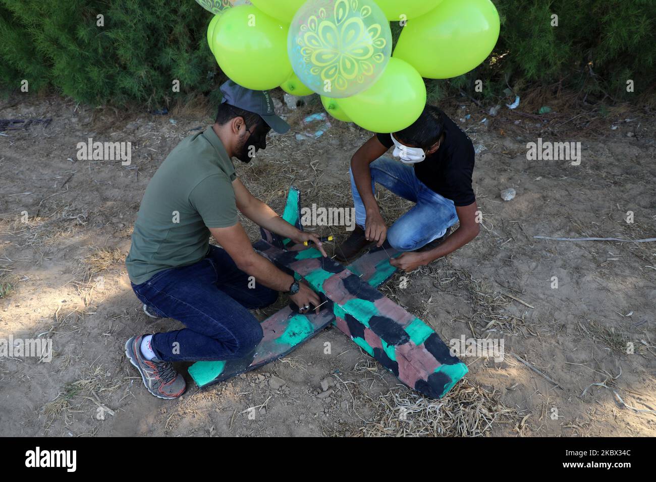 Masked Palestinians attach incendiary devices to balloons before ...