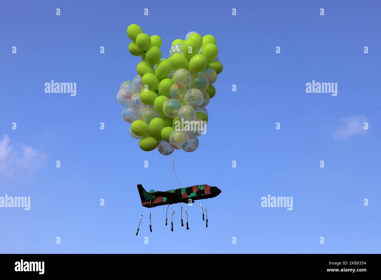 Balloons carrying an incendiary device float in the air upon release by ...