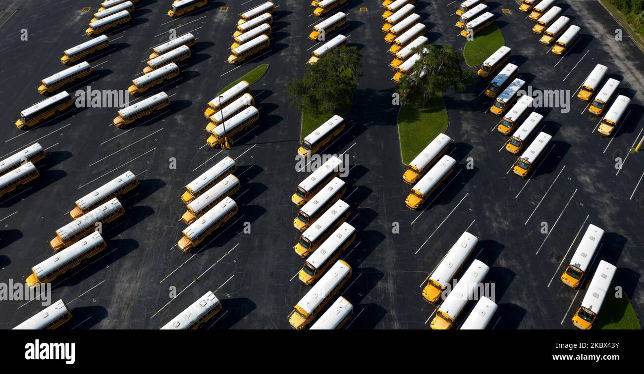 In this aerial view from a drone, school buses are seen parked at the ...
