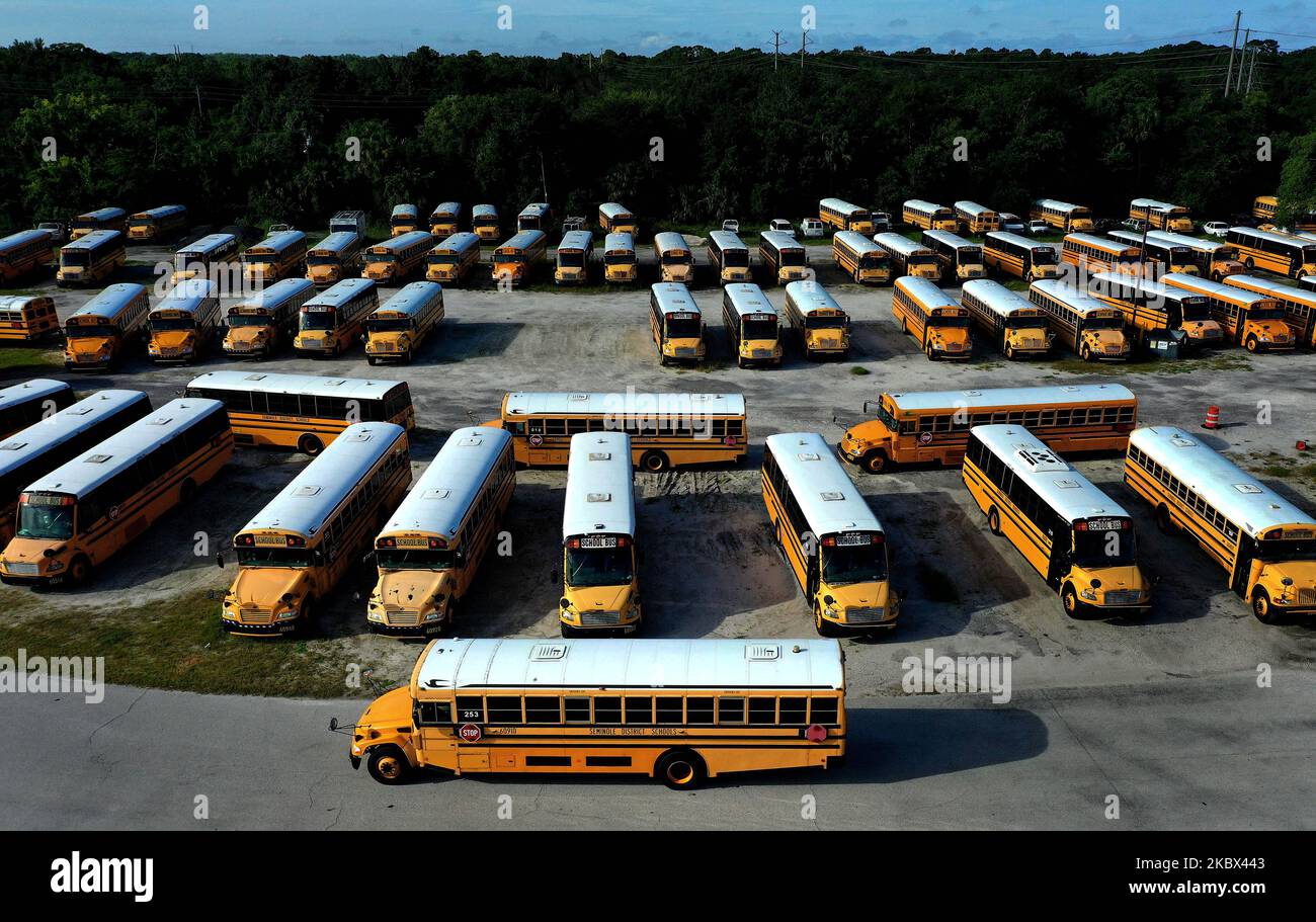 In this aerial view from a drone, school buses are seen parked at the ...