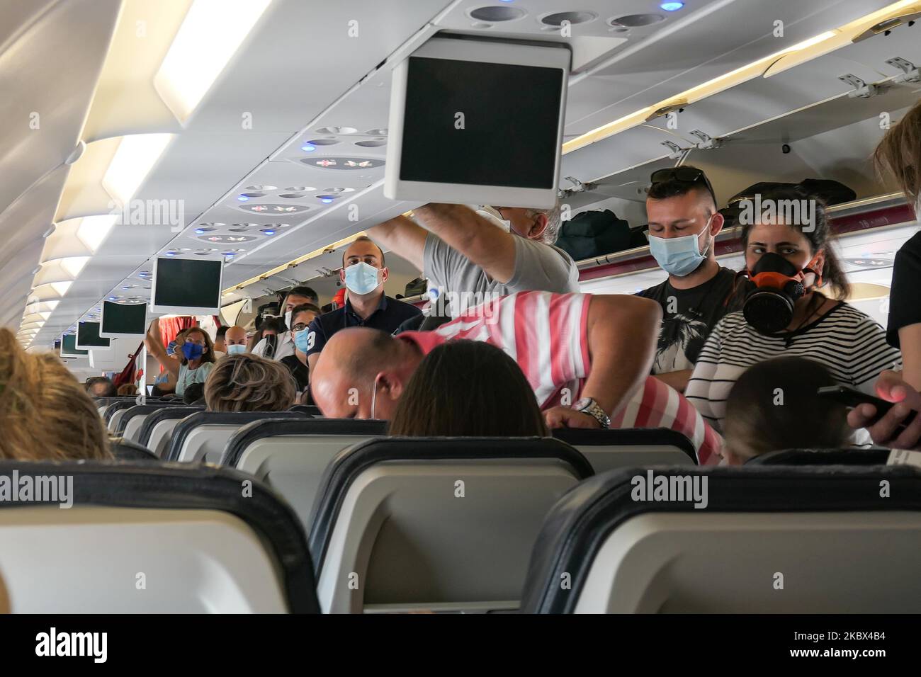 Passengers with facemasks boarding inside an Aegean Airbus A320. Flying ...