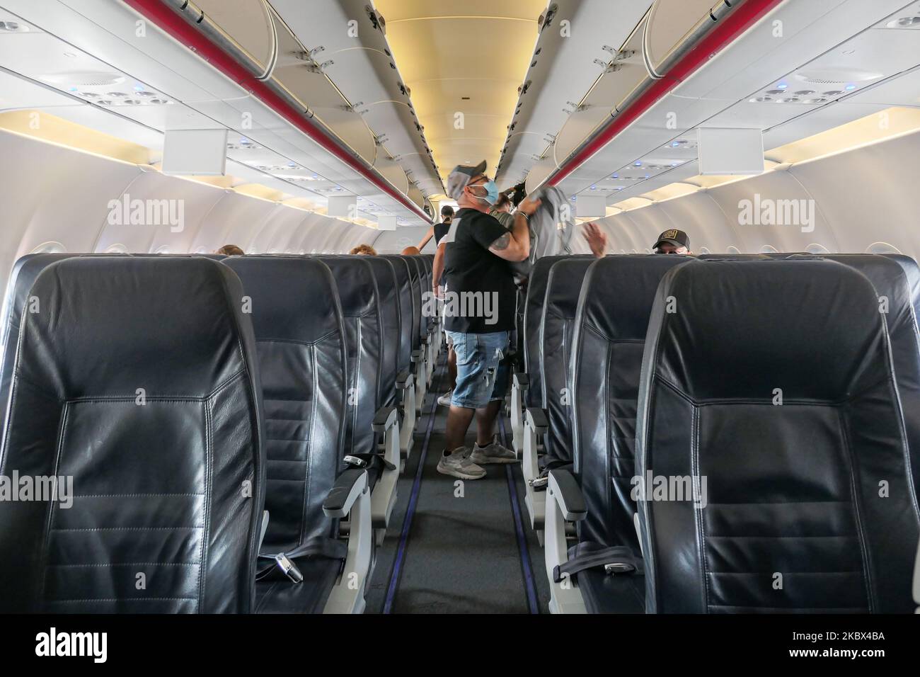 Passengers with facemasks boarding inside an Aegean Airbus A320. Flying ...