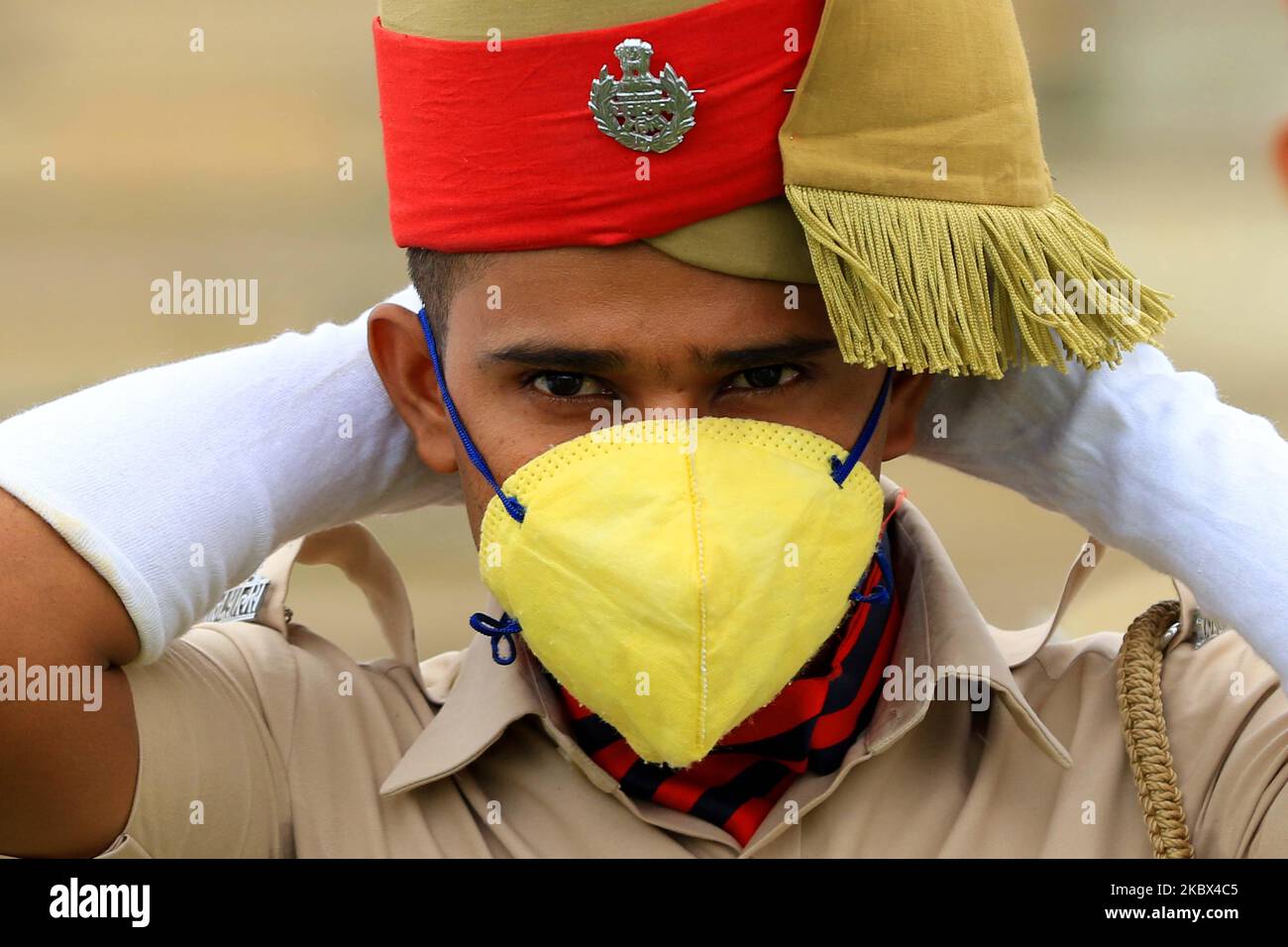 Indian police personnel wearing face masks take part in a final ...