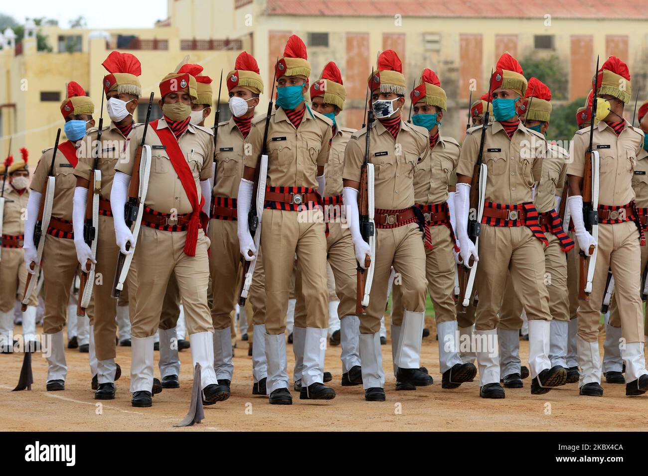 Indian police personnel wearing face masks take part in a final ...