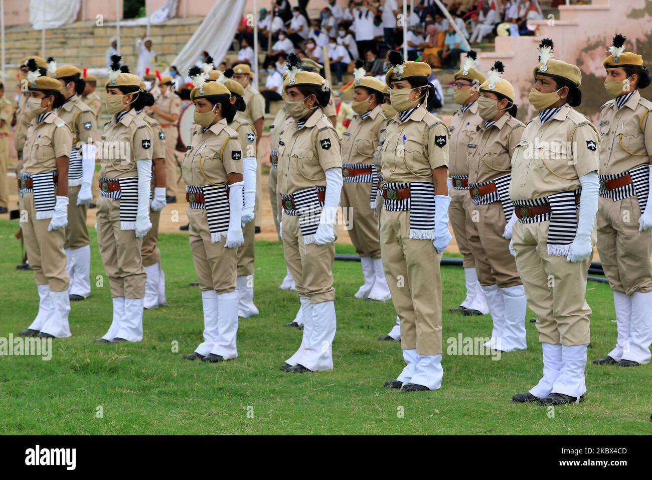Indian police personnel wearing face masks take part in a final ...