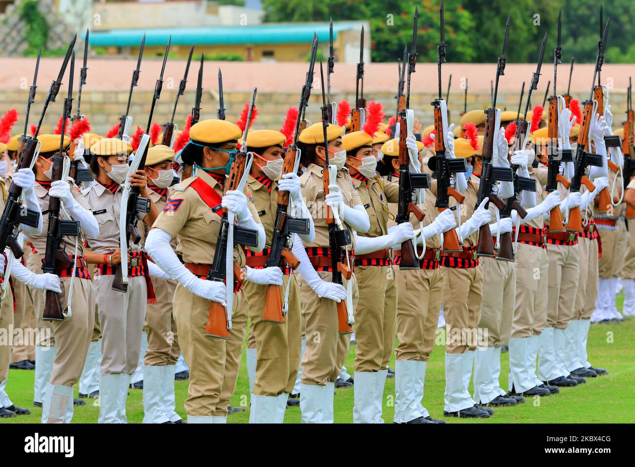 Indian police personnel wearing face masks take part in a final ...