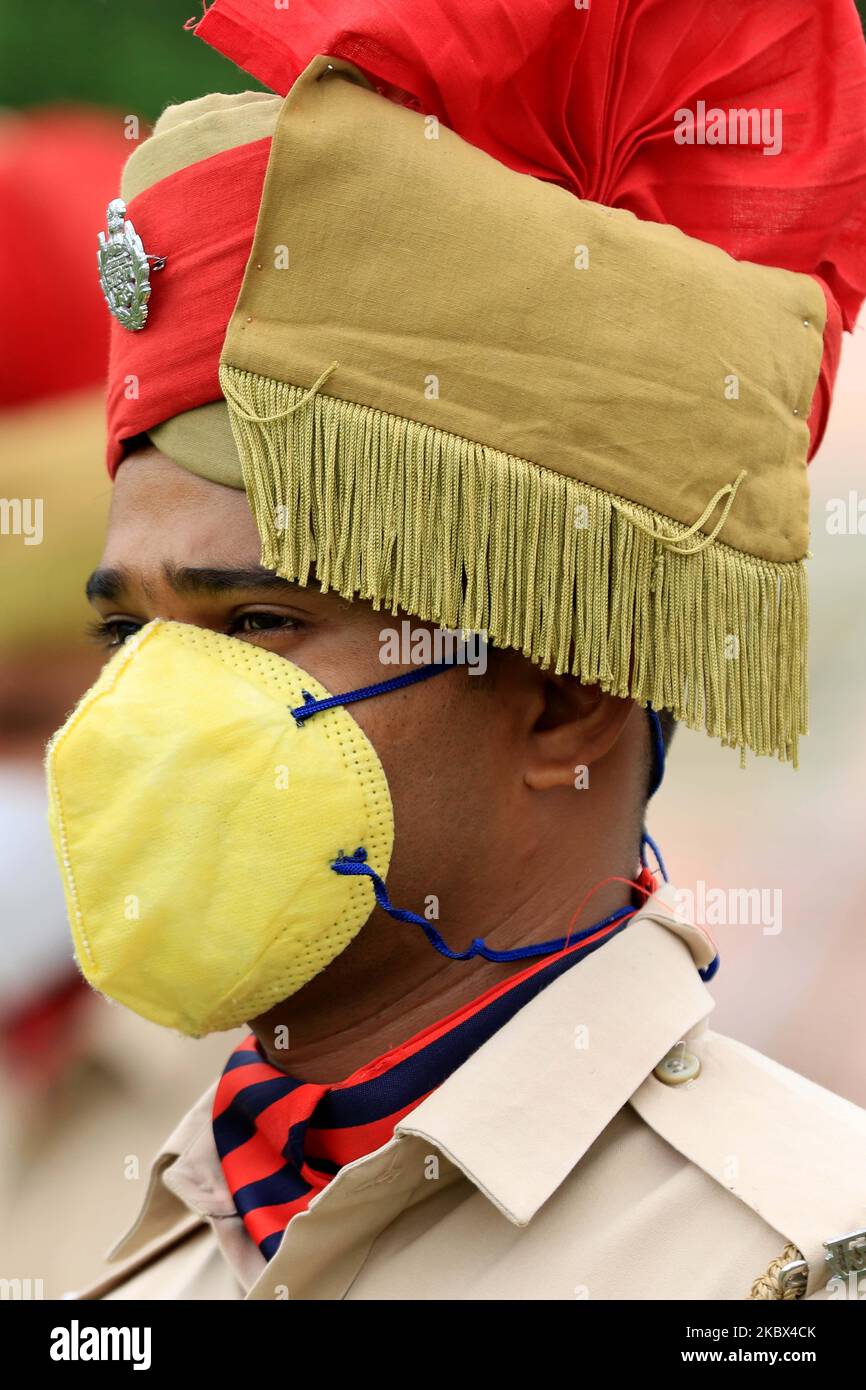 Indian police personnel wearing face masks take part in a final ...