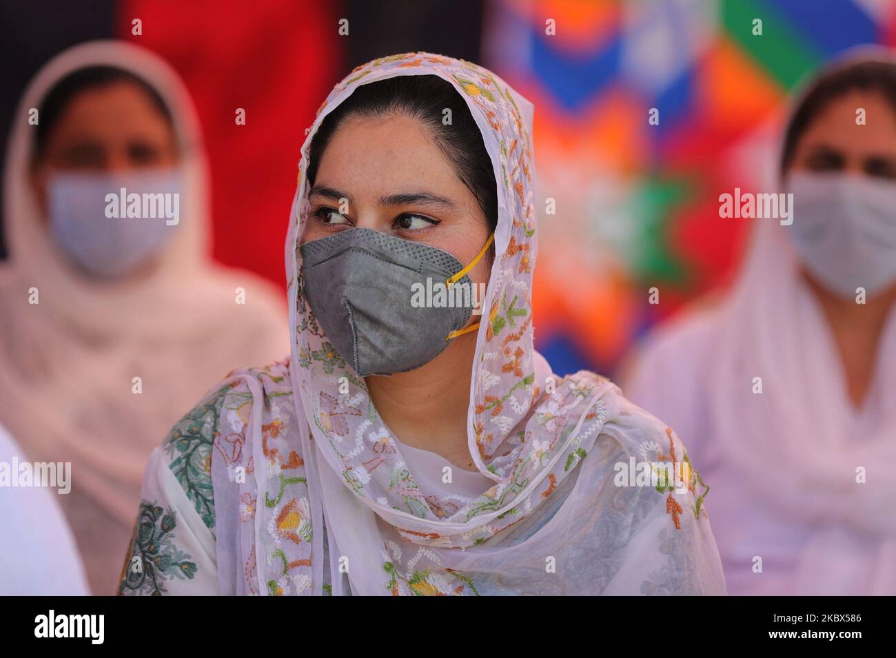 People wear face masks as they watch the 74th India's Independence day ...