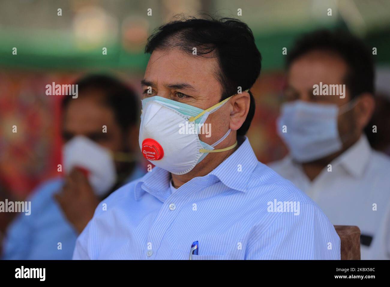 People wear face masks as they watch the 74th India's Independence day ...