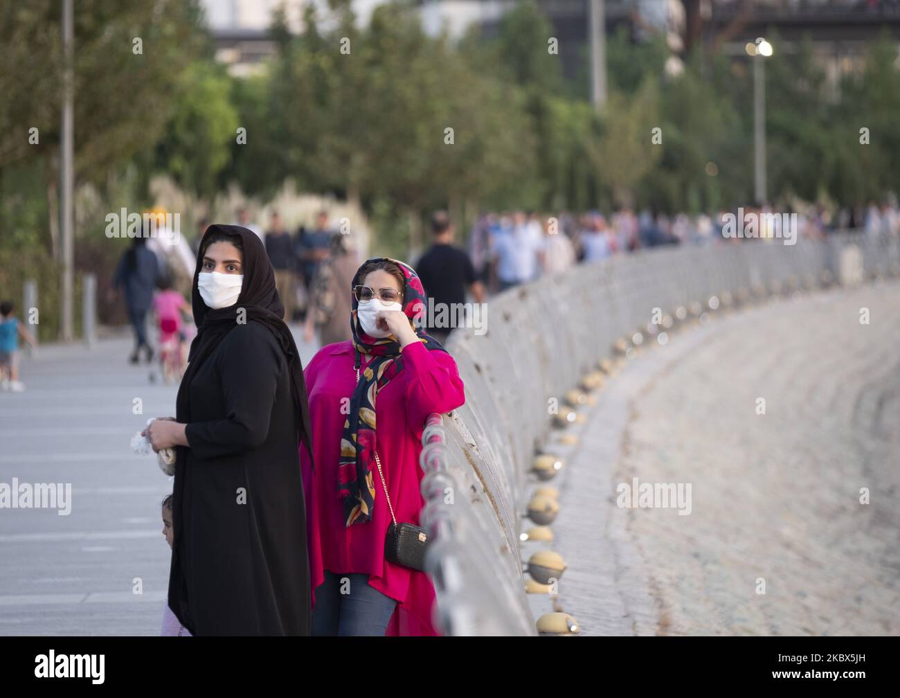 Two Iranian women wearing protective face masks stand in the ...