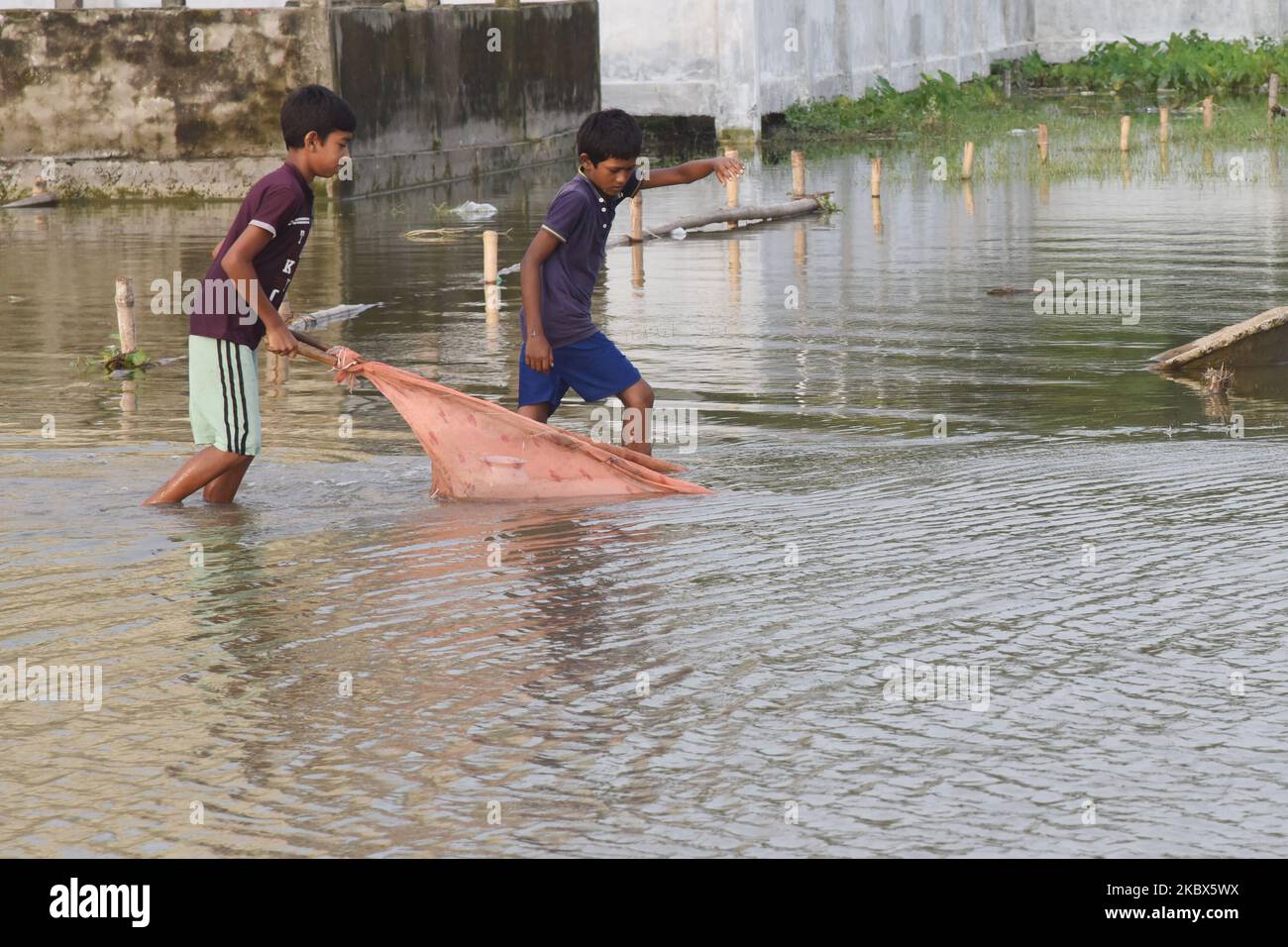 Village children fishing in flood water at Savar near Dhaka, Bangladesh ...