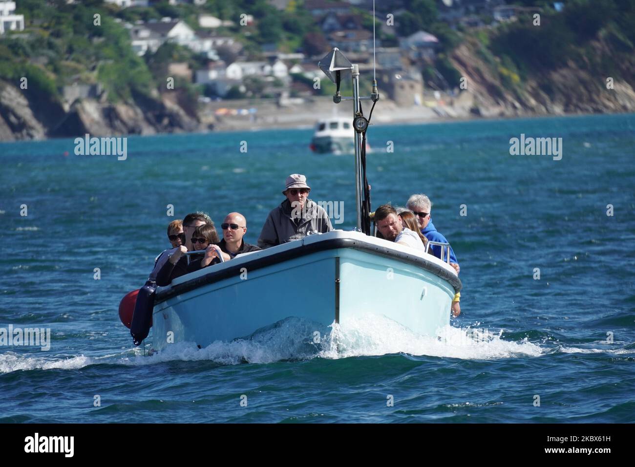 A number of people on a small boat taking a trip to Looe Island in the ...