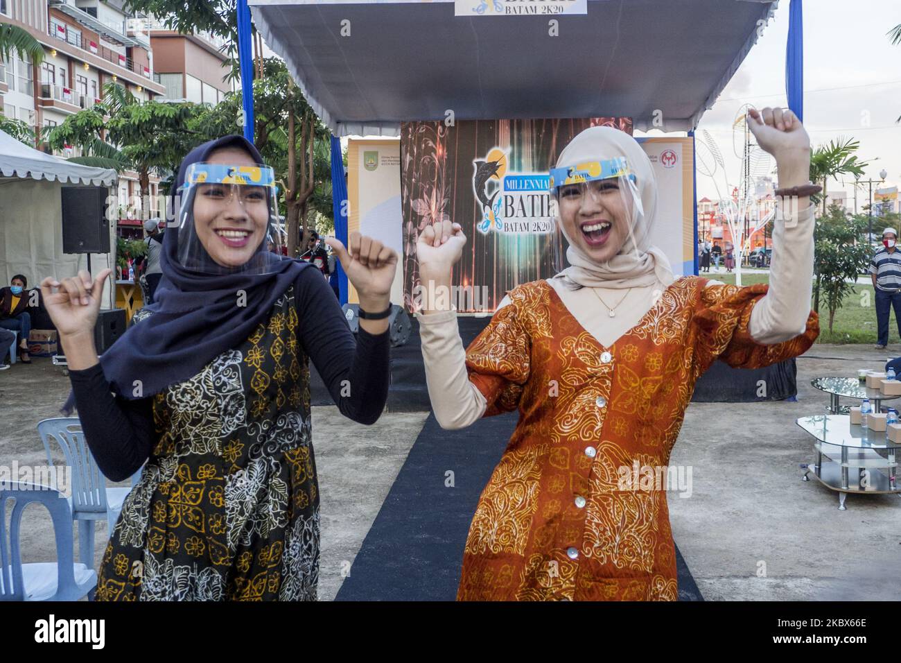 The models demonstrate a fashion design at a batik fashion show typical ...