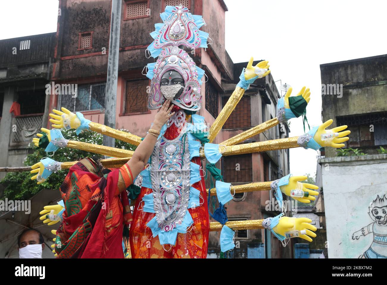 Hindu Goddess Durga idol wearing Silver face Mask and surgical mask ...