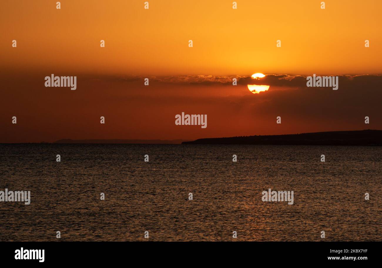 Sunset in the ocean with clouds and orange colour. Seascape in the ...