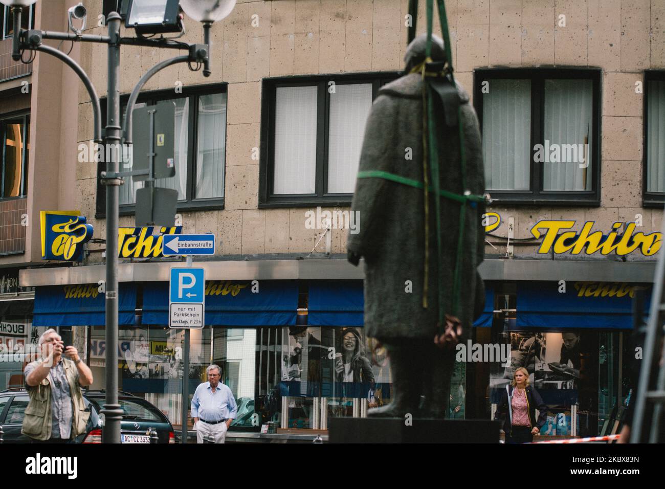 people takes pictures as Konrad Adenauer statue is being installed in ...