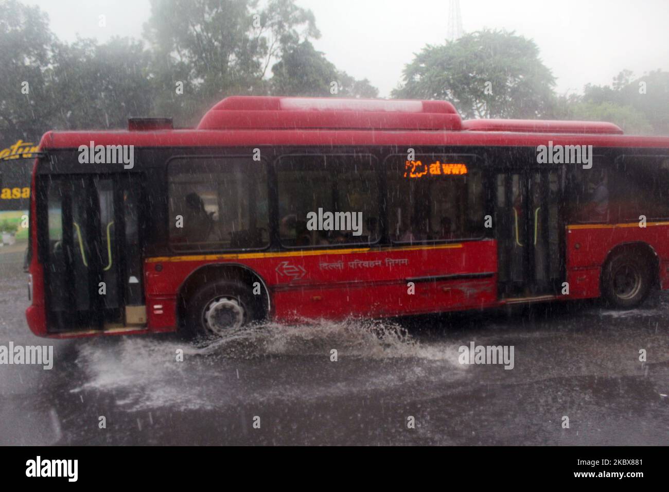A bus passes amid heavy rain pounded the national capital and its ...