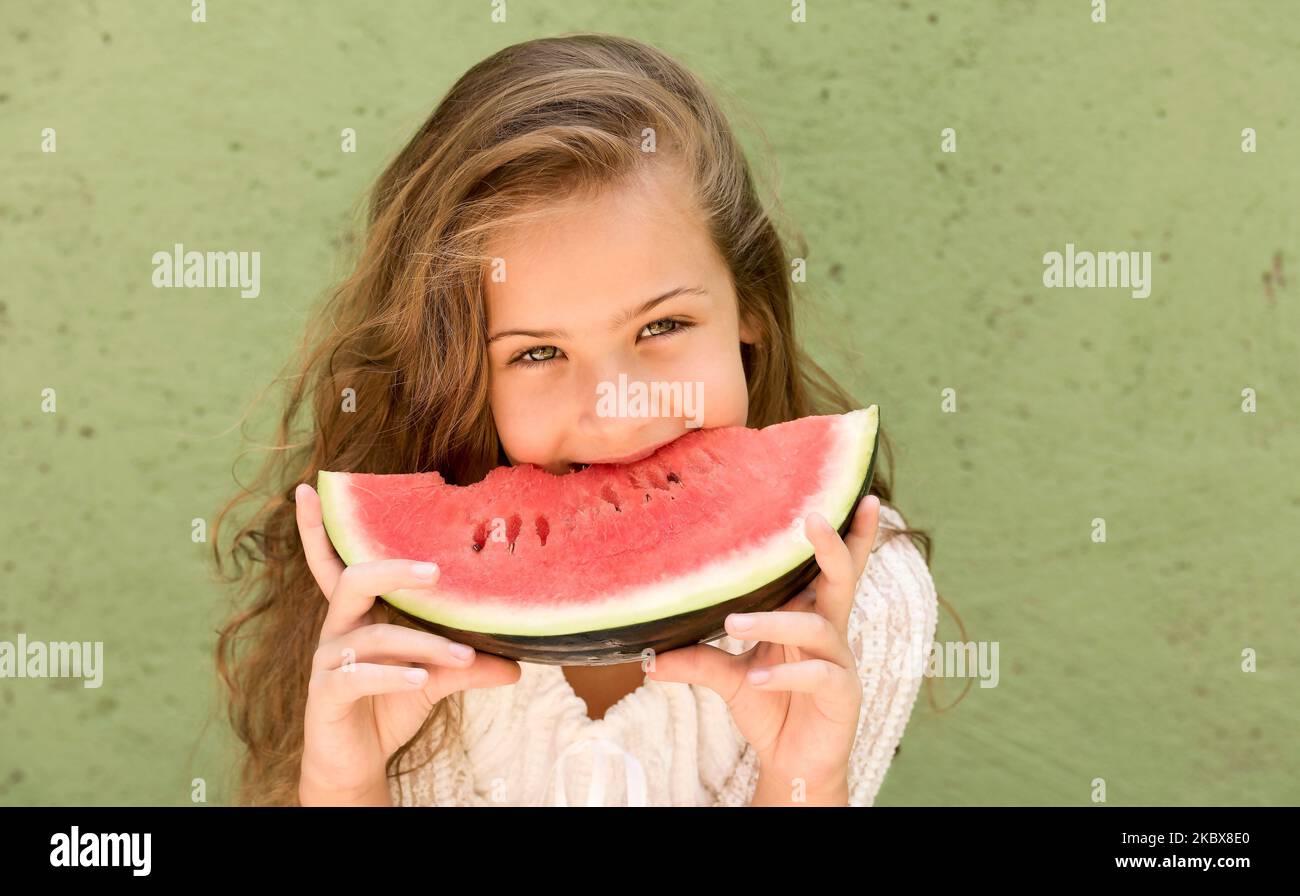 Beautiful happy girl eats juicy watermelon Stock Photo - Alamy
