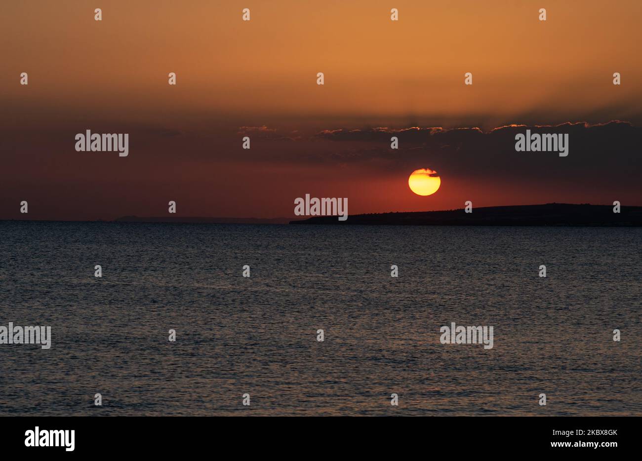 Sunset in the ocean with clouds and orange colour. Seascape in the ...