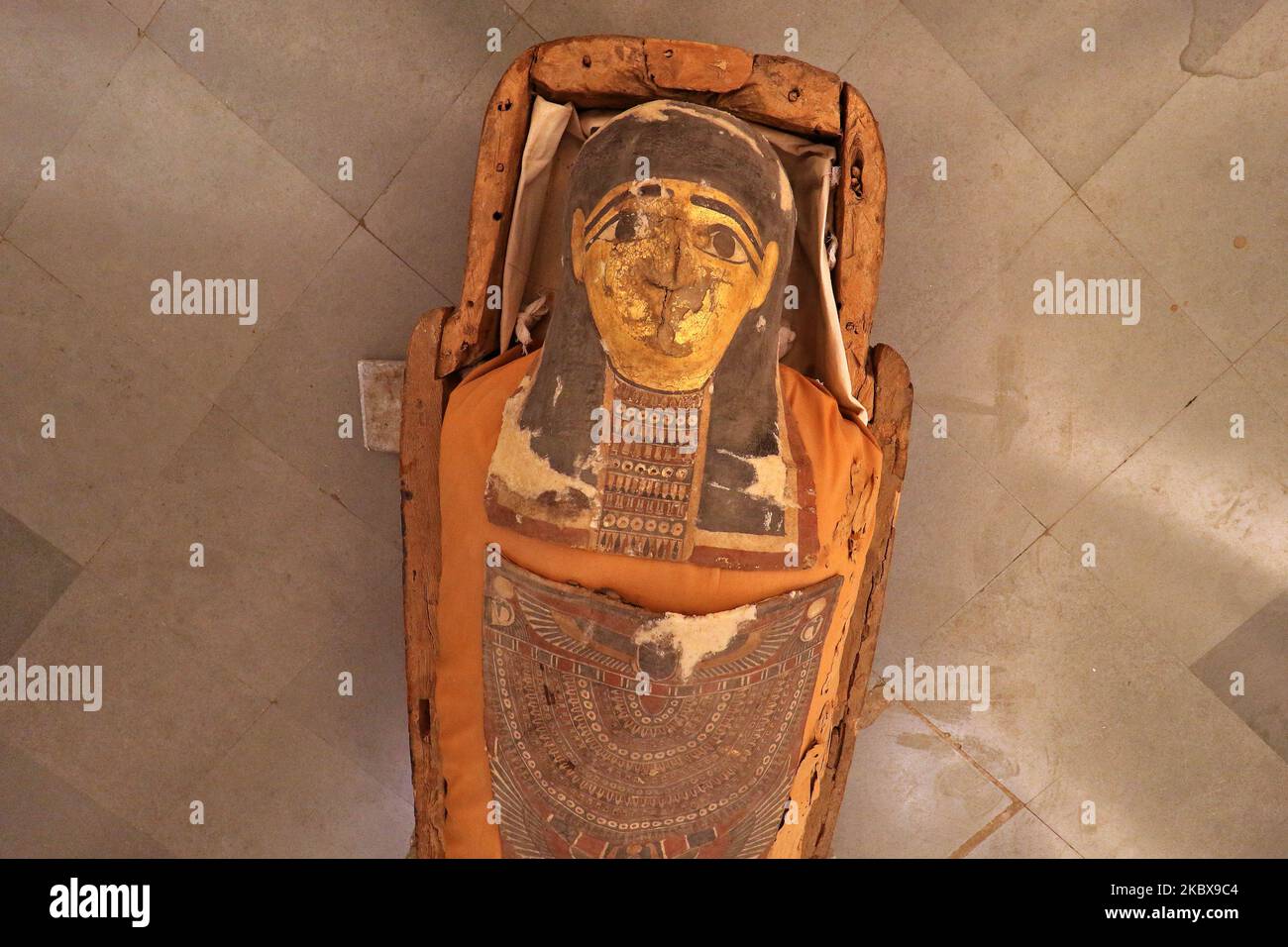 A 2400-year old mummy kept out of its box at a safe place after rain ...