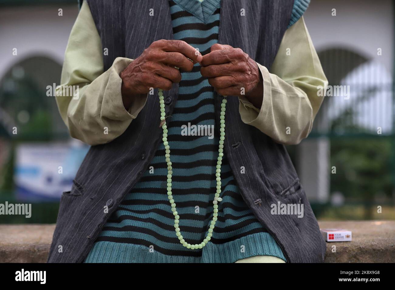 A Muslim man with prayer beads prays outside Jama Masjid Sopore after ...