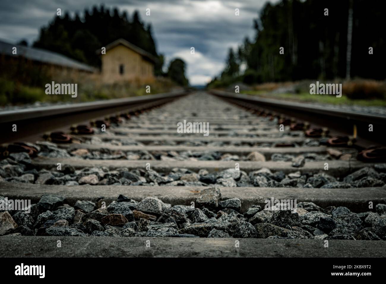Pebbles and rails of a train on a cloudy day Stock Photo - Alamy