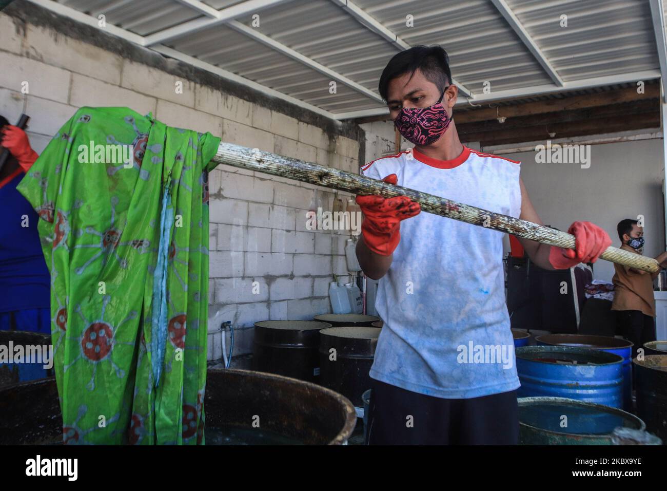 Workers finished making batik cloth with the corona virus pattern at a ...
