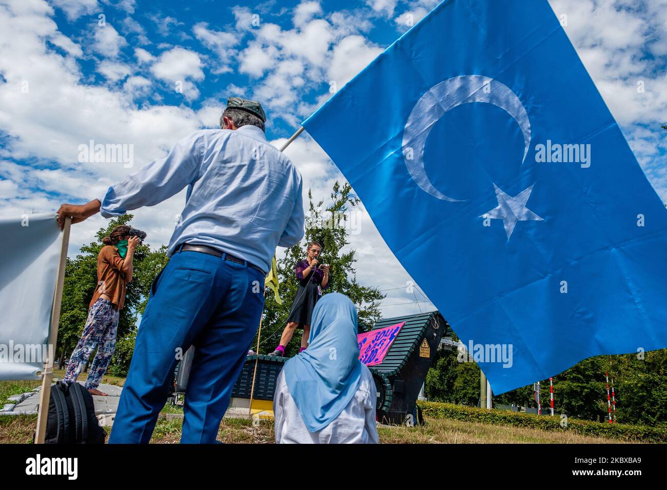 An Uyghur man and her daughter and listening the speeches, during the ...