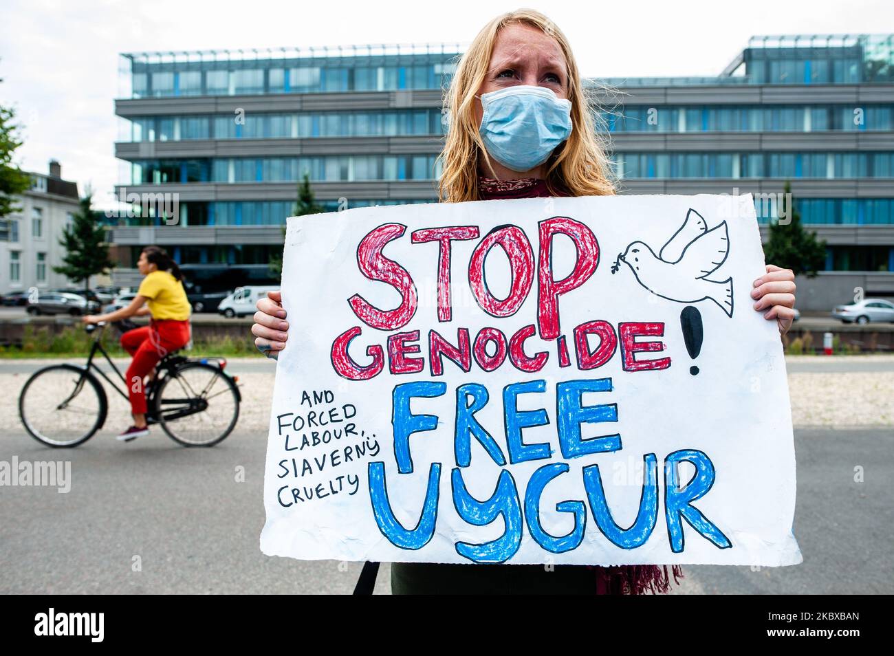 A Dutch woman is holding a placard in support of the Uyghurs, during ...