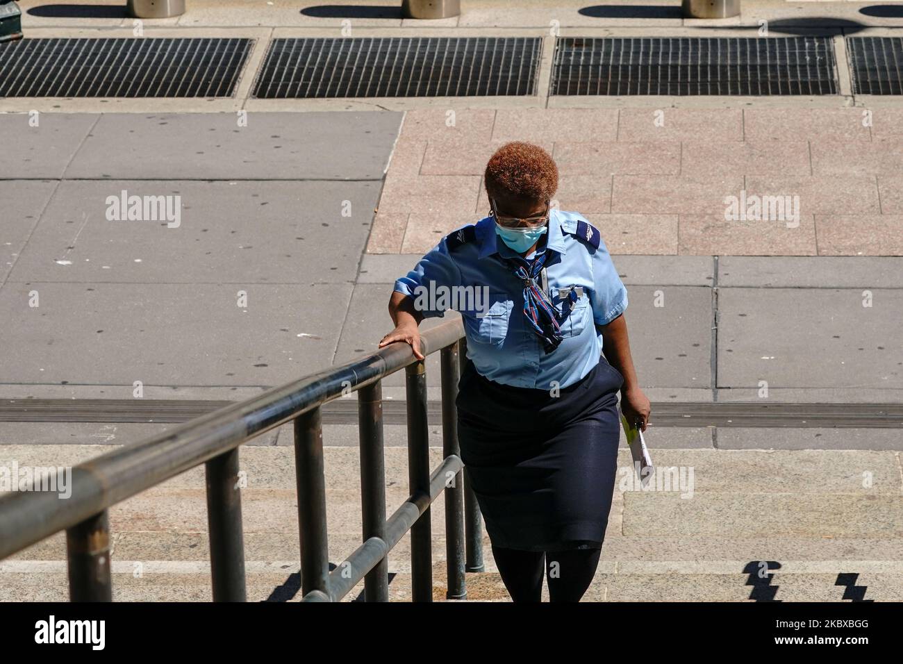 A USPS worker is seen in front of The James A. Farley Building, it is ...