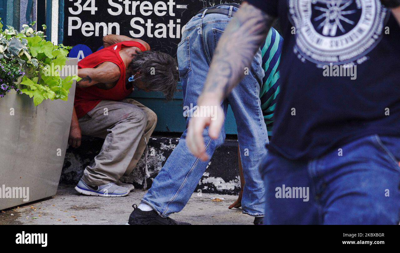 A couple of men nod out on the street from heroin high onNew York City ...