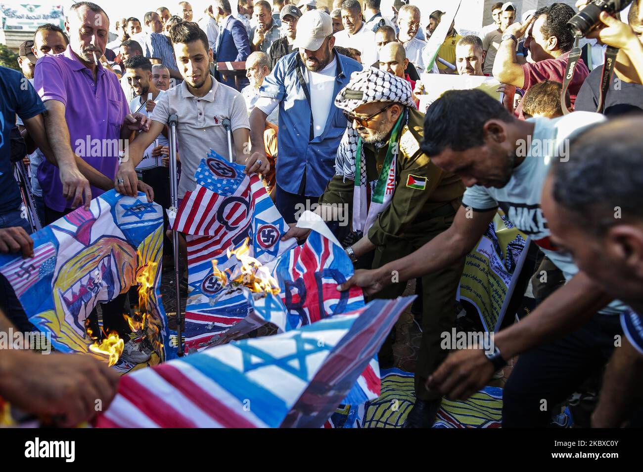 Palestinians during a protest against the United Arab Emirates' deal ...