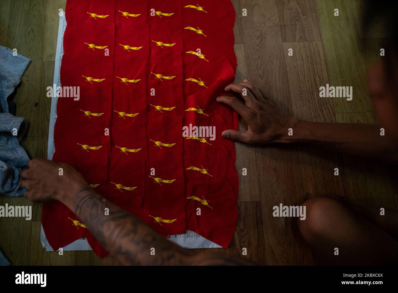 A man arranges logos of the National League for Democracy (NLD) onto T ...