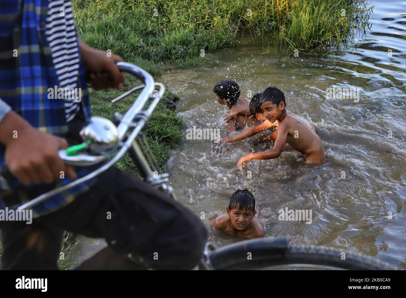 Kids taking bath in a irrigation canal in Sopore town of District ...