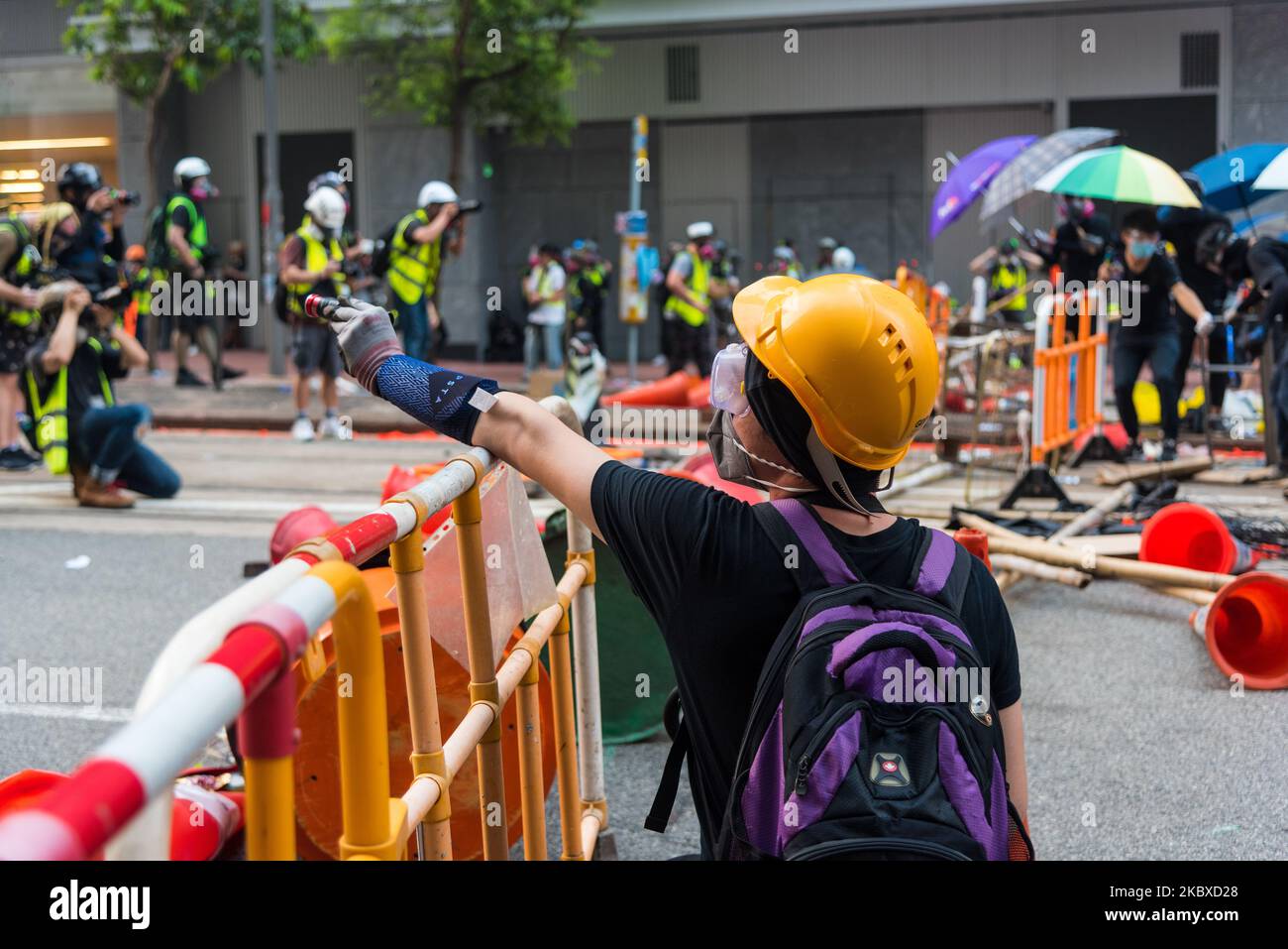 A female protester shines a laser pointer on riot police in Admiraltyin ...