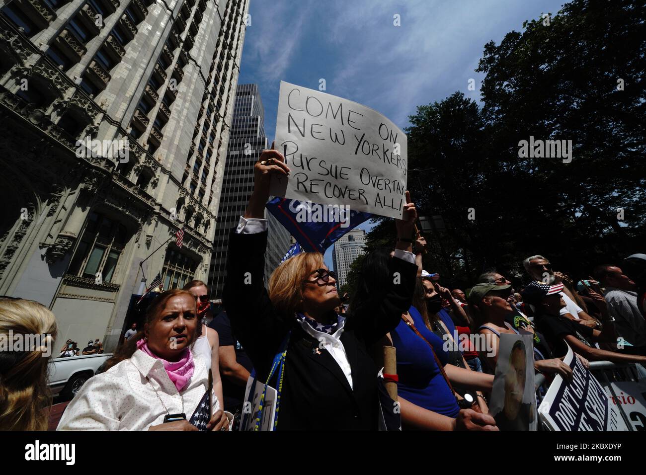 A protestor is seen holding a placard as Artist Scott Lobaido Hosts ...