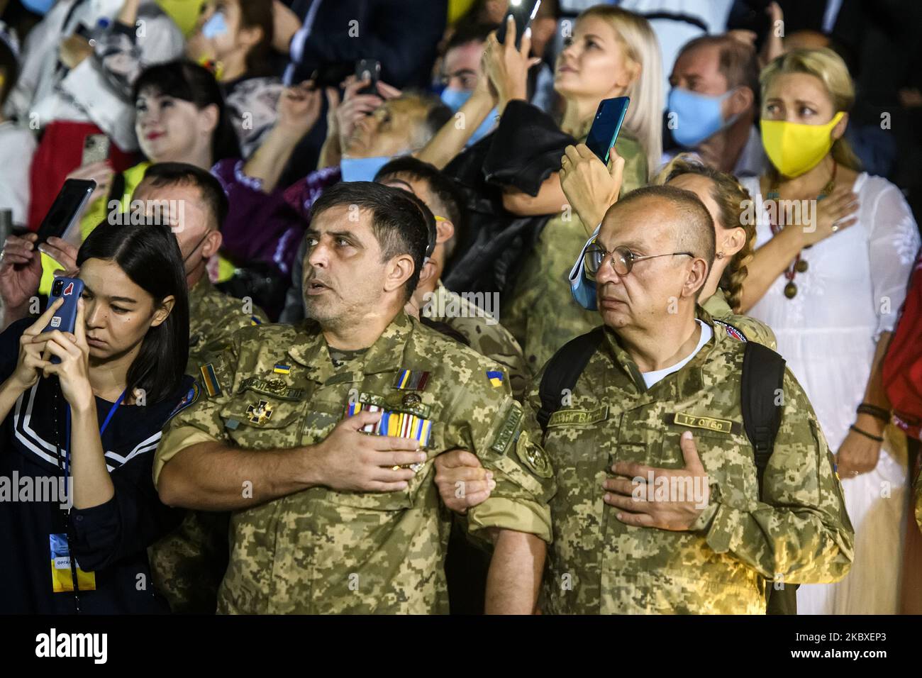 Veterans of the war in eastern Ukraine sing the anthem during the ...